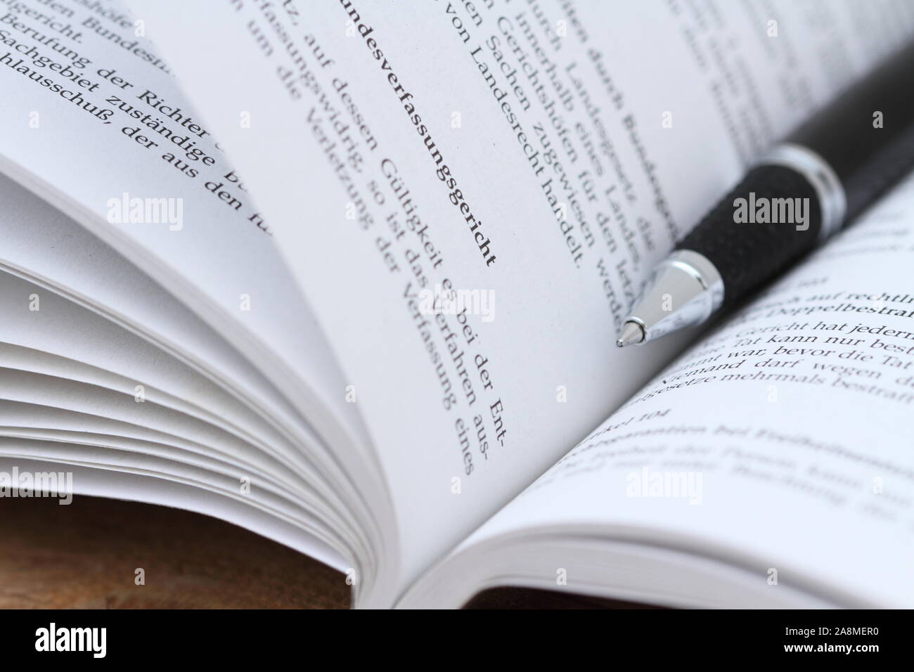 an open book with pen and the text "article Stock Photo - Alamy