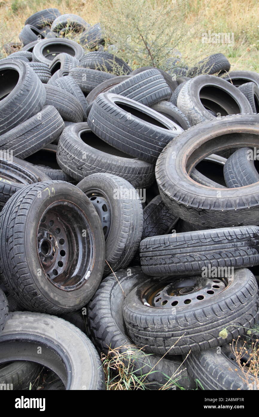 old tires discarded in nature Stock Photo - Alamy