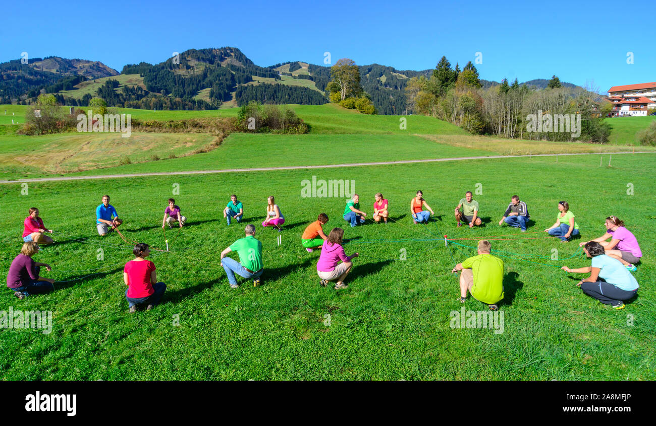 Teambuilding exercise called ball transport complex Stock Photo - Alamy