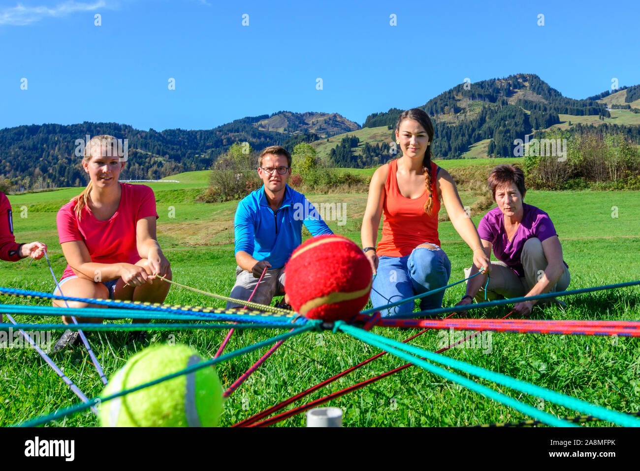 Teambuilding exercise called ball transport complex Stock Photo - Alamy