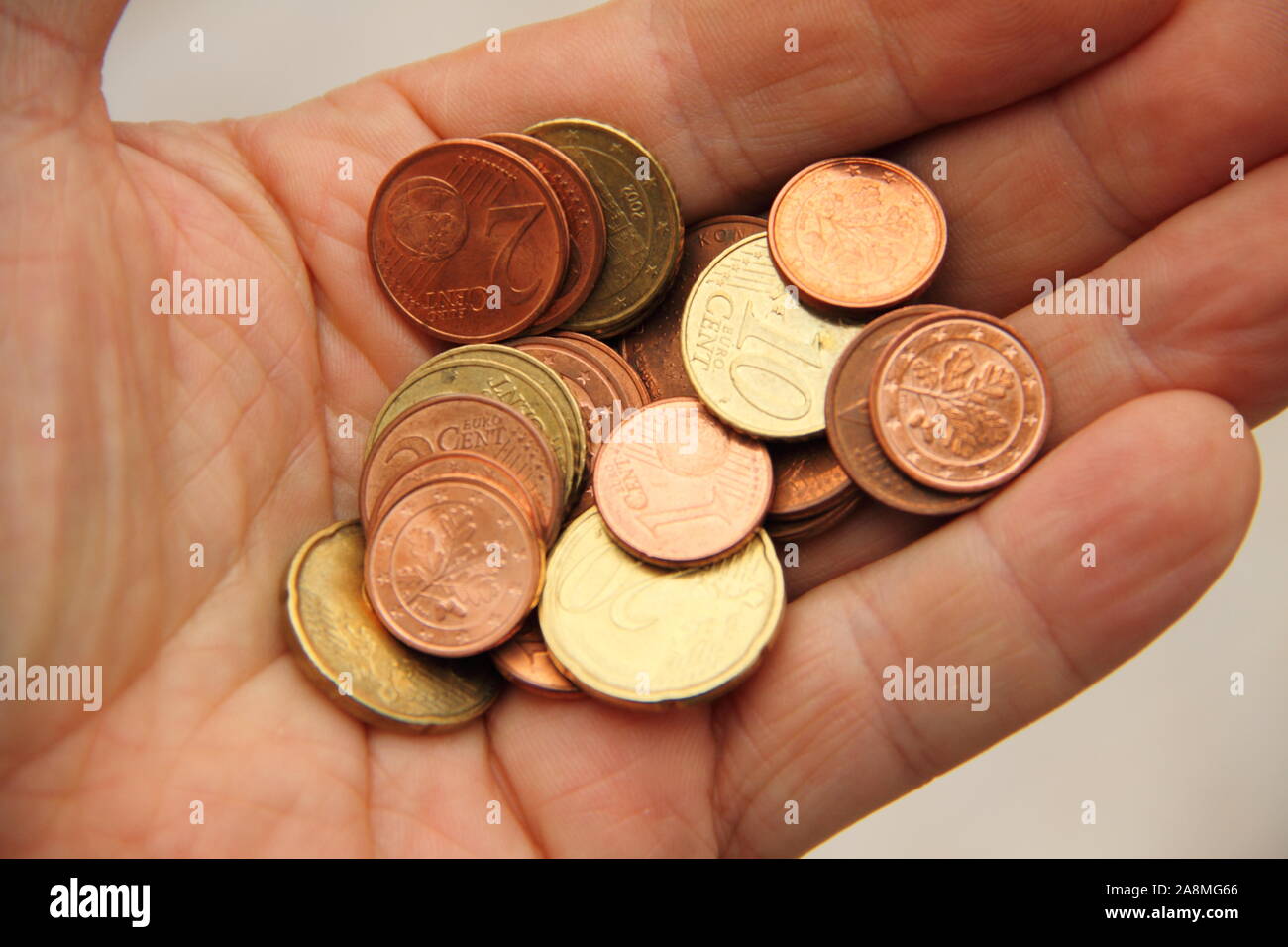 a handful of small money Stock Photo - Alamy