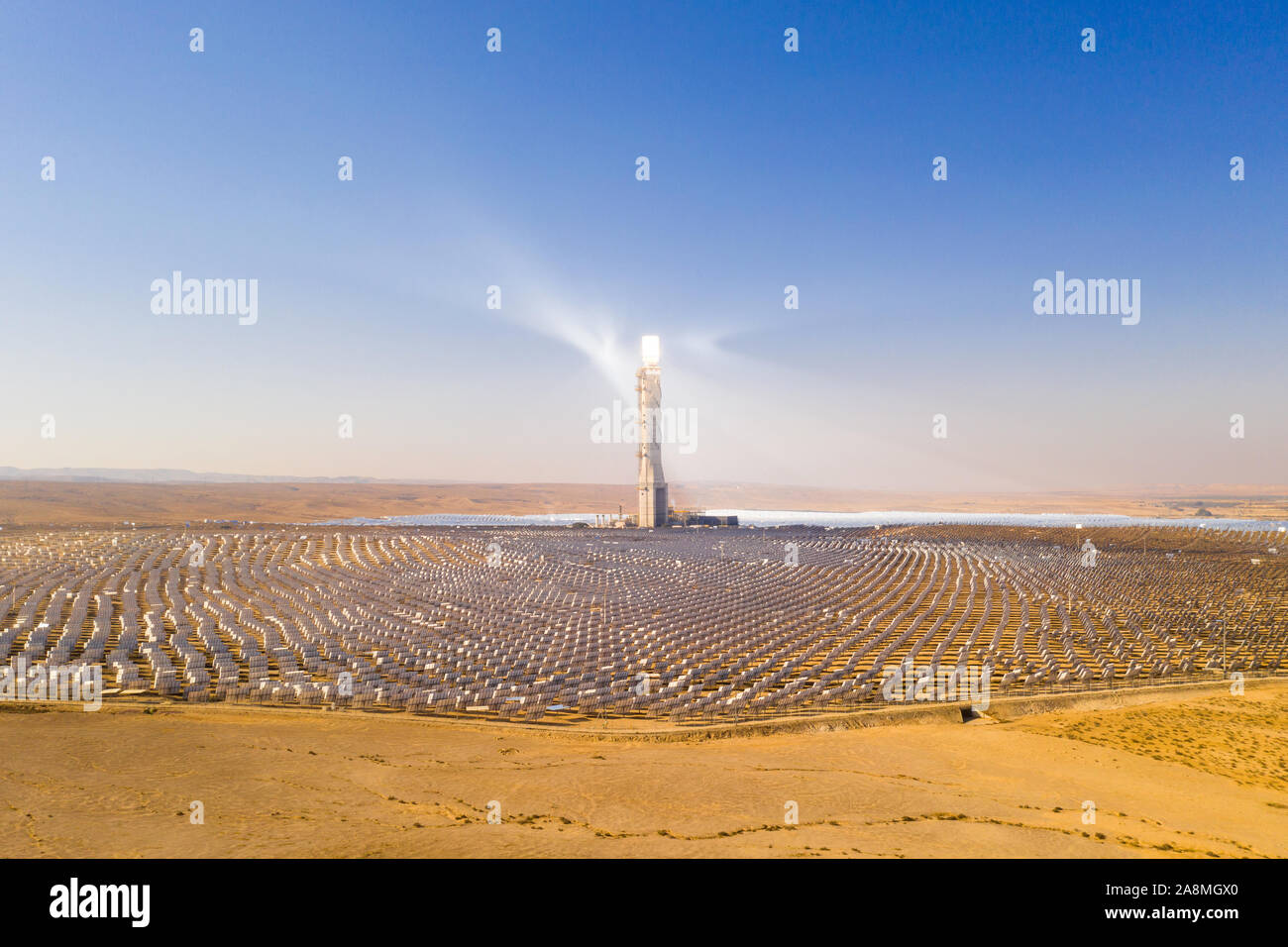 Solar power plant mirrors that focus the sun's rays upon a collector ...
