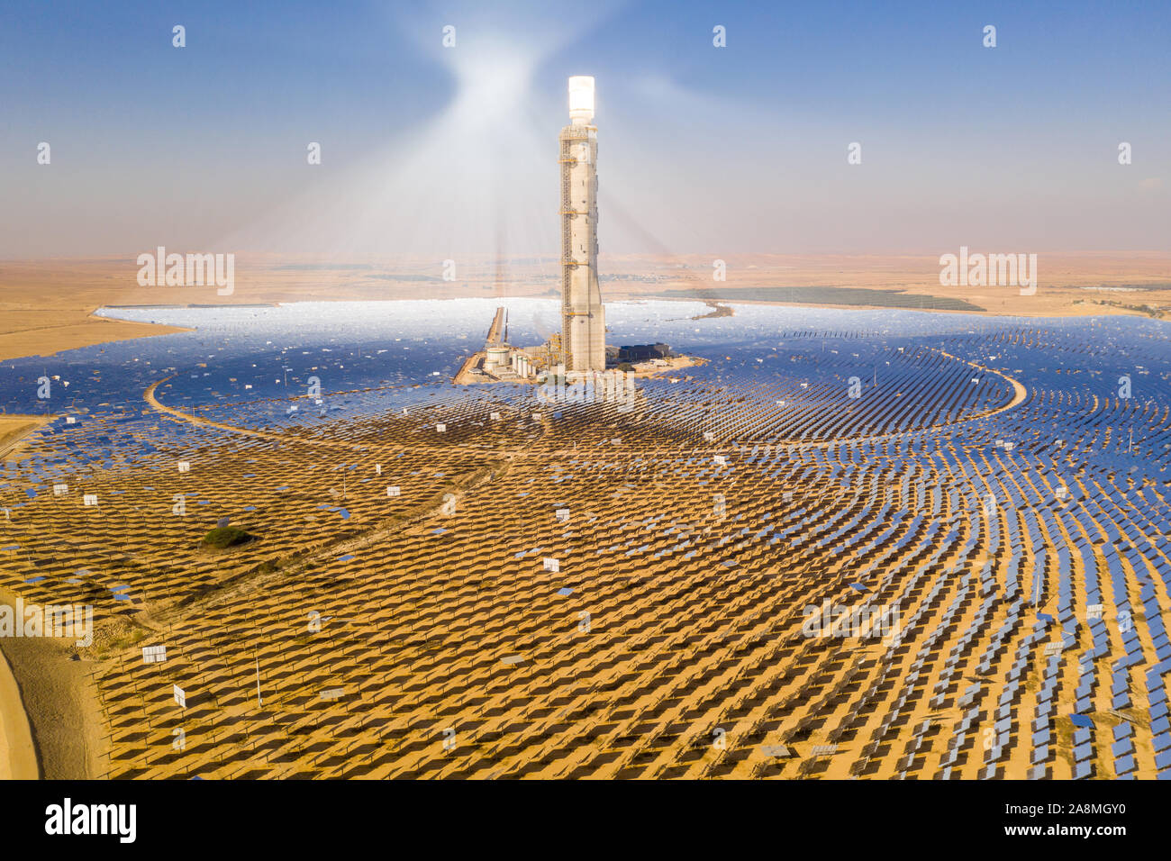Solar power plant mirrors that focus the sun's rays upon a collector ...