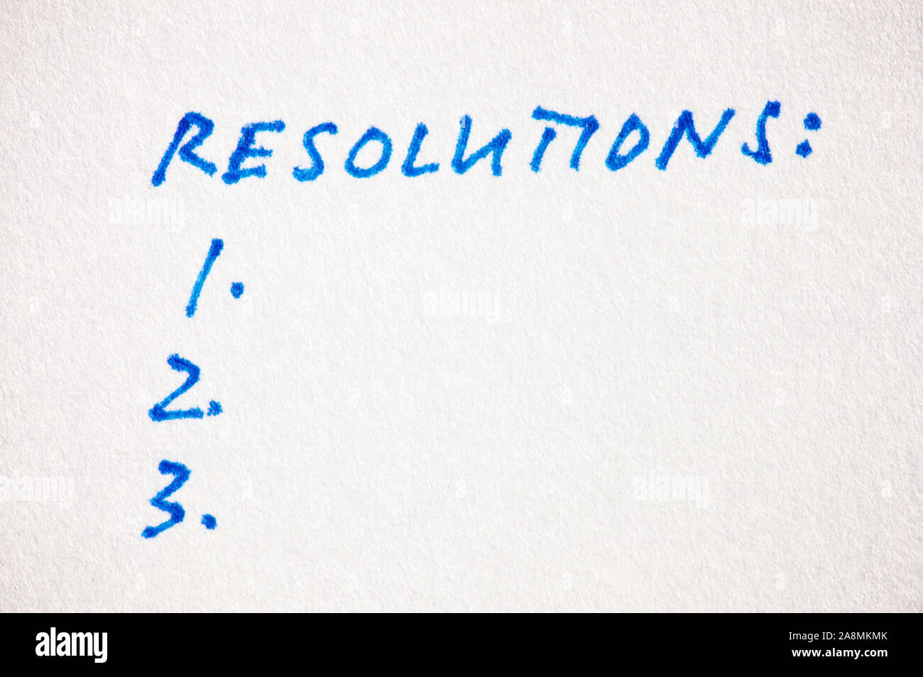 Handwritten resolutions list for the new year in blue ink on textured ...