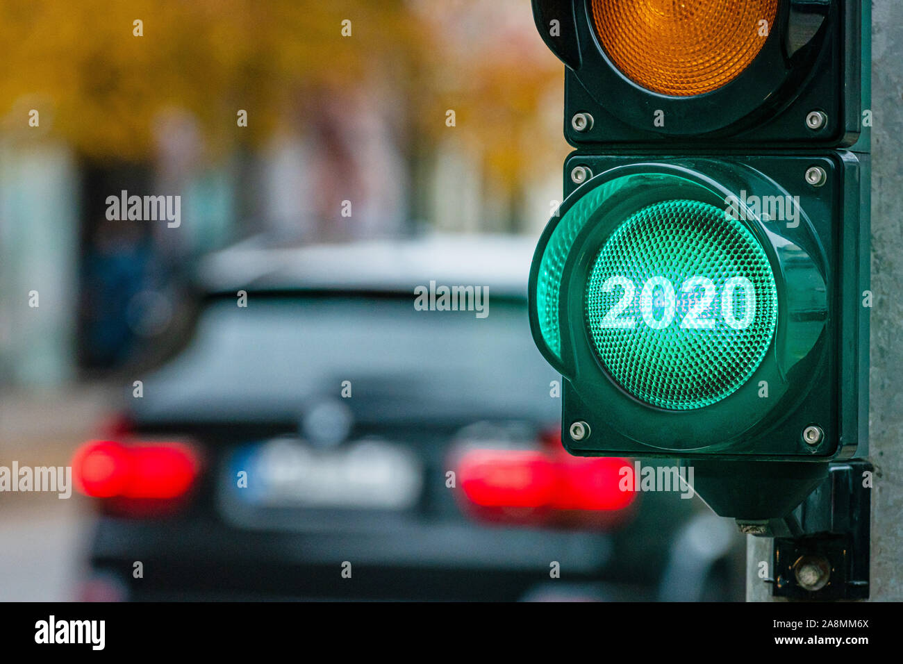 A city crossing with a semaphore. Green light with text 2020 in ...