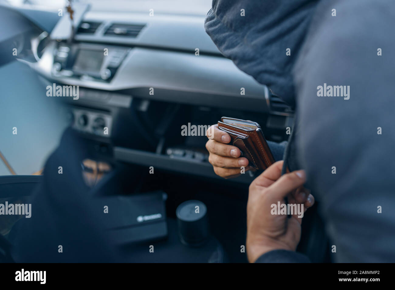 Car robber takes the wallet, stealing Stock Photo - Alamy