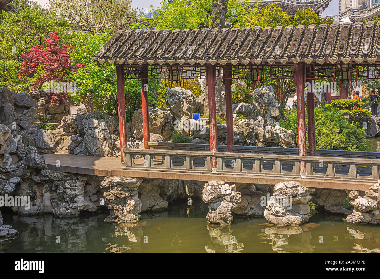 Editorial: SHANGHAI, CHINA, April 18, 2019 - Covered bridge over a pond ...