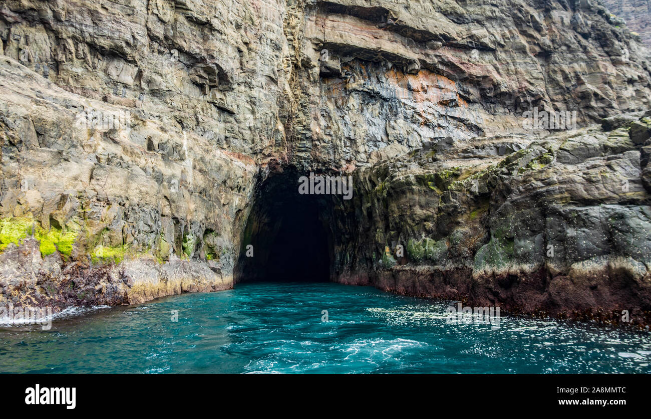 Entering the hole under the the mountain Stock Photo - Alamy