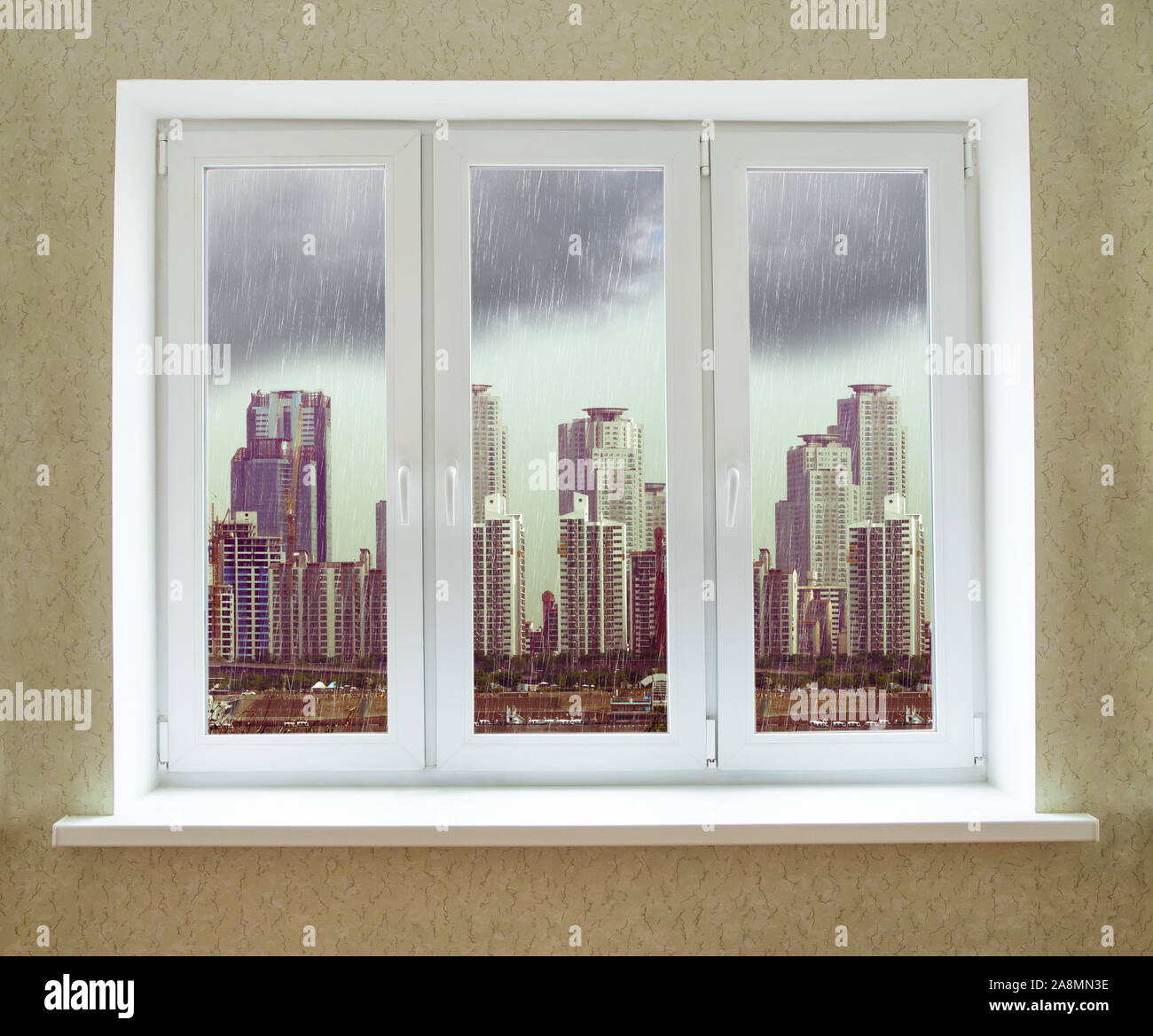 View through a modern PVC window onto rainy city landscape Stock Photo ...