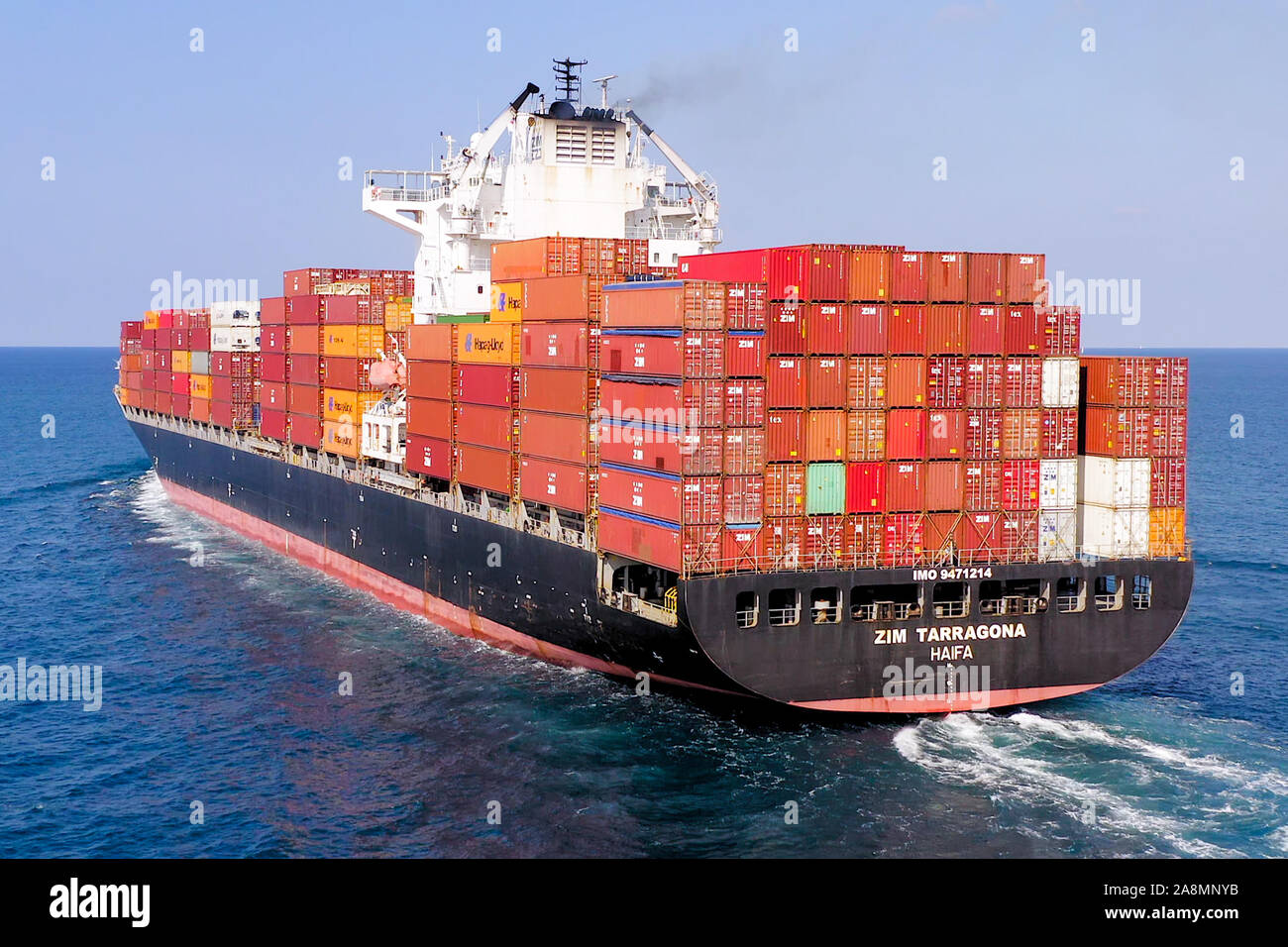 Zim Tarragona loaded Container ship cruising away from port, Aerial ...