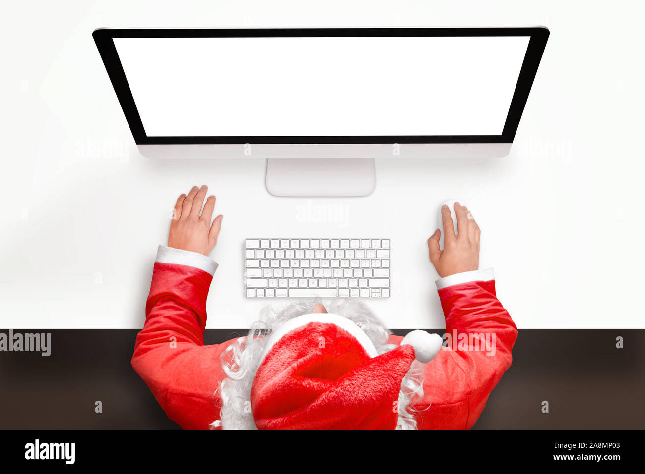 Santa work on computer with isolated screen for mockup. View from above ...