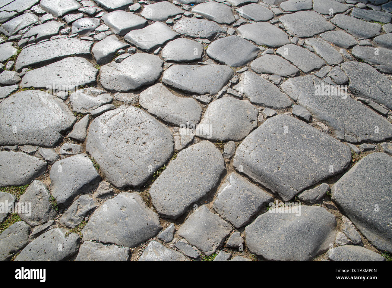 A fragment of the original cobblestone pavement of time-worn stones ...