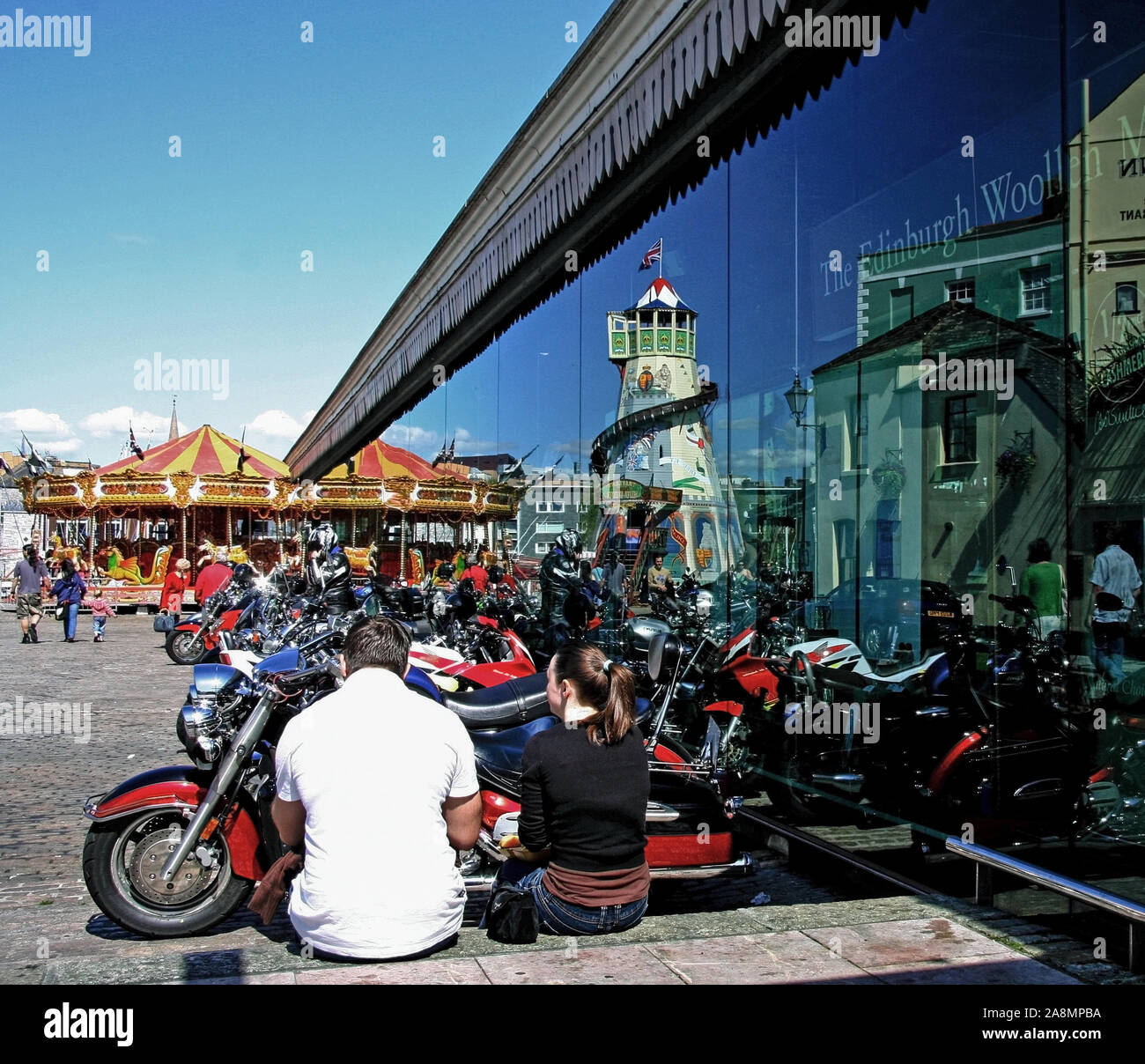 Bikes and scooters reflected in the glass of the old fish market on ...
