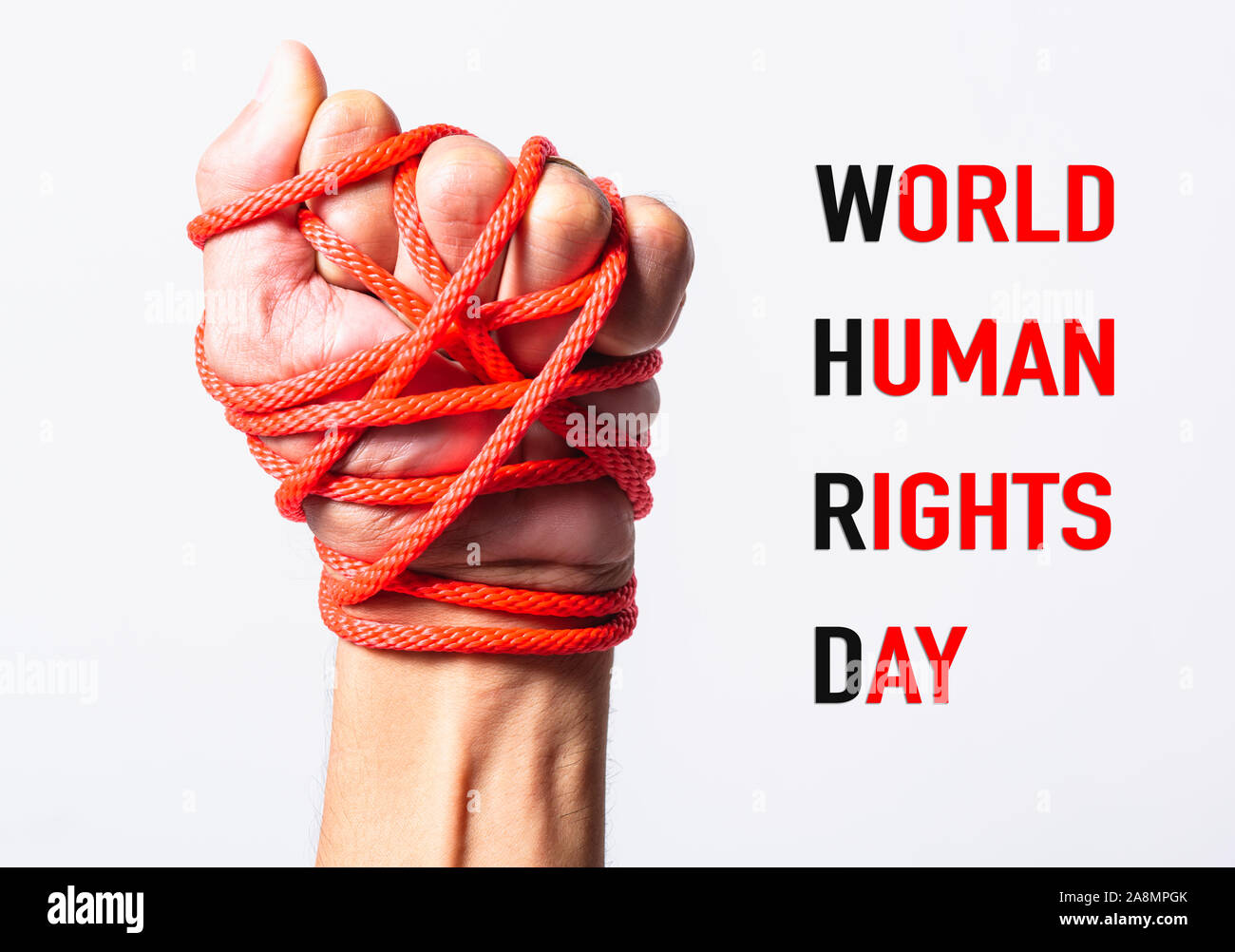 Red rope on fist hand with WORLD HUMAN RIGHTS DAY text on white ...