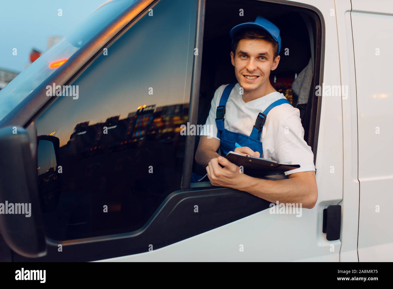 Deliveryman drives a car, delivery service Stock Photo - Alamy
