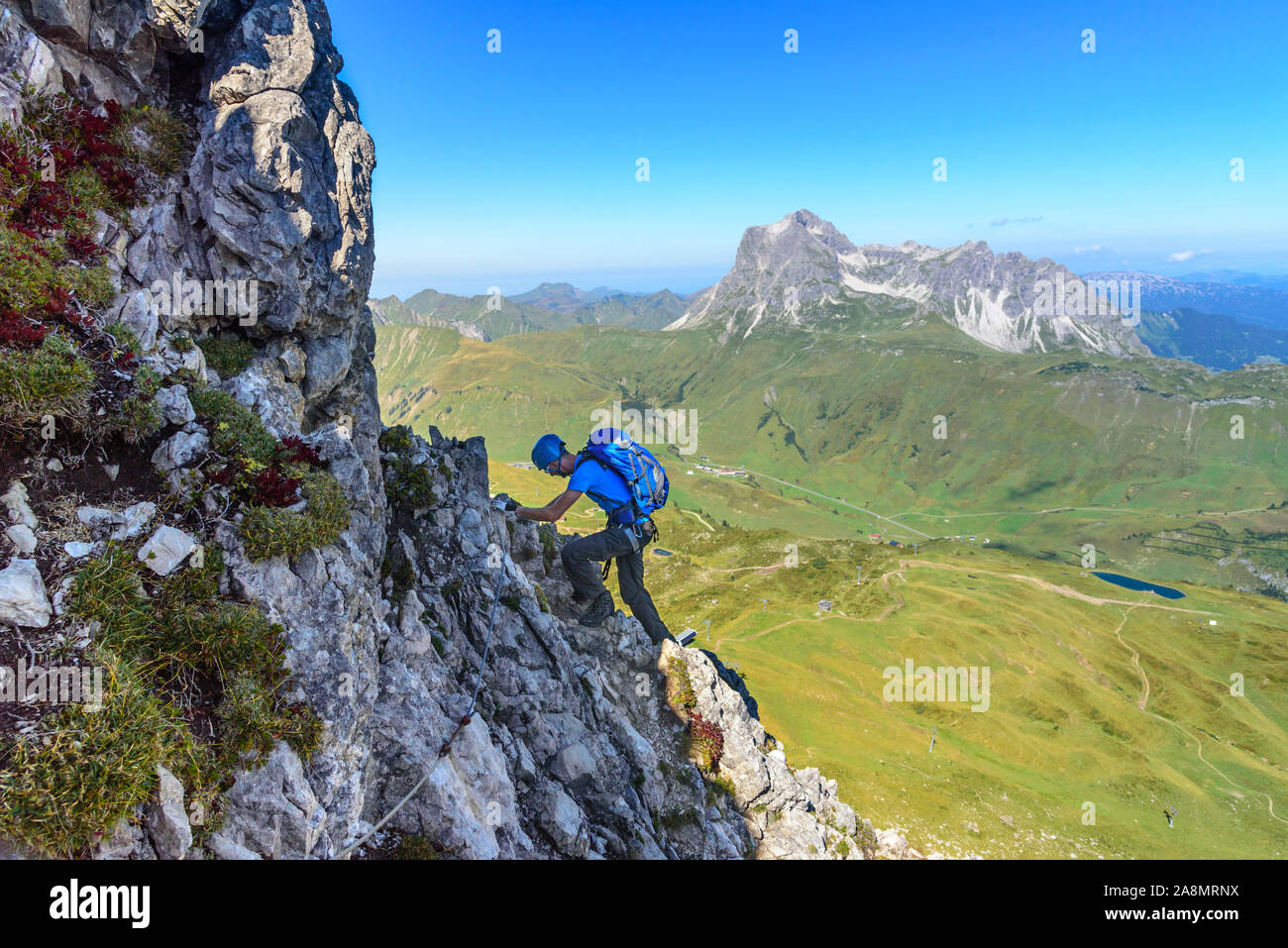 Climbing in via ferrata style in high alpine region in western Austria ...