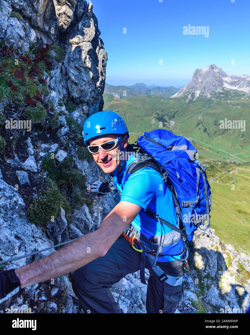 Climbing in via ferrata style in high alpine region in western Austria ...