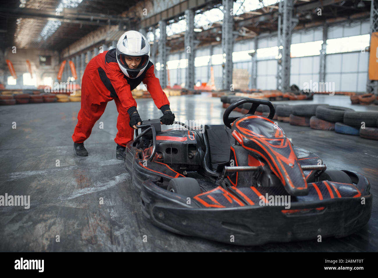 Racer in helmet pushing a go kart car, karting Stock Photo - Alamy