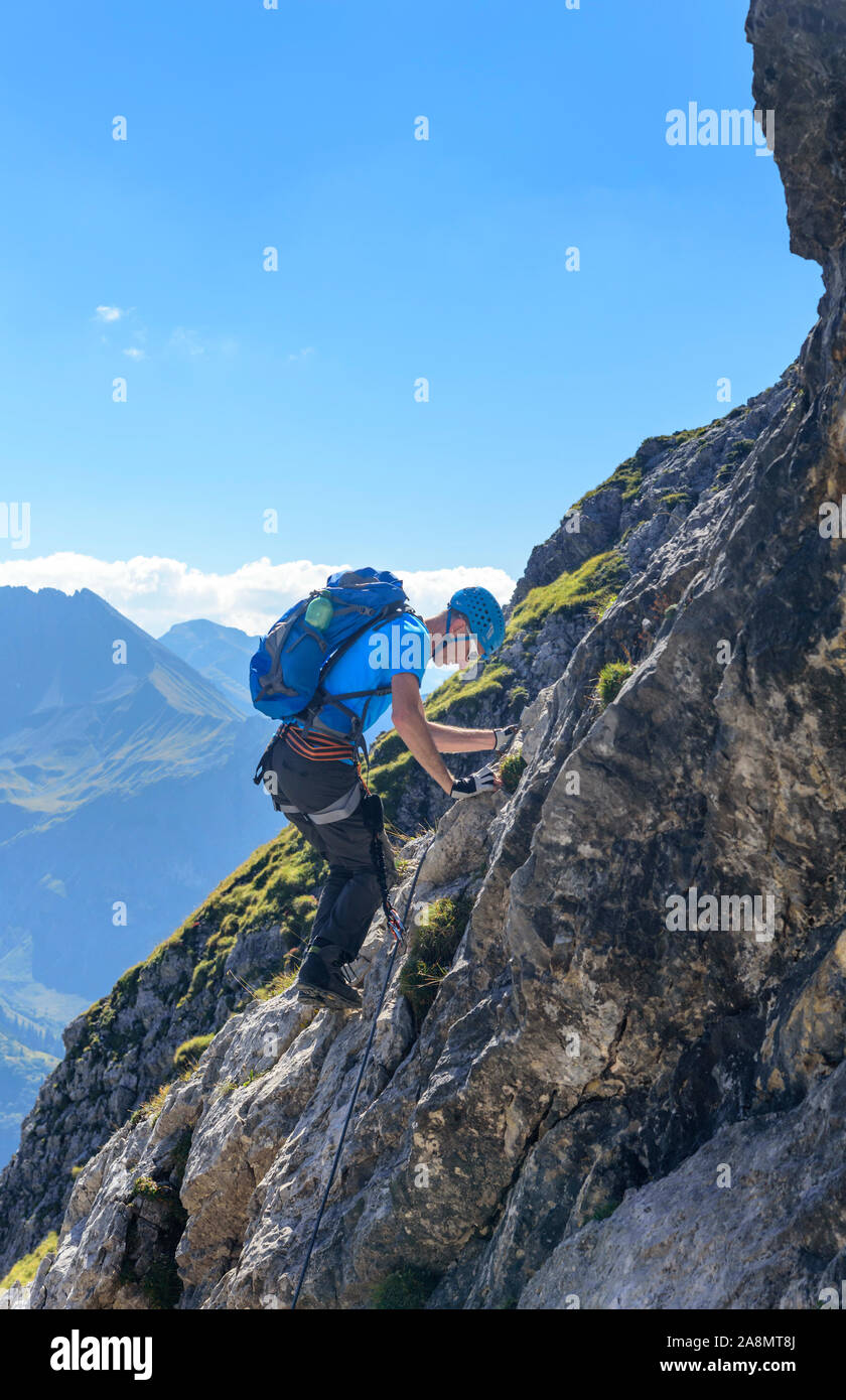 Climbing in via ferrata style in high alpine region in western Austria ...