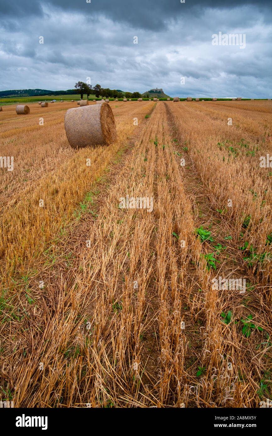 Hay bales on the field after harvest and behind, second biggest castle ...