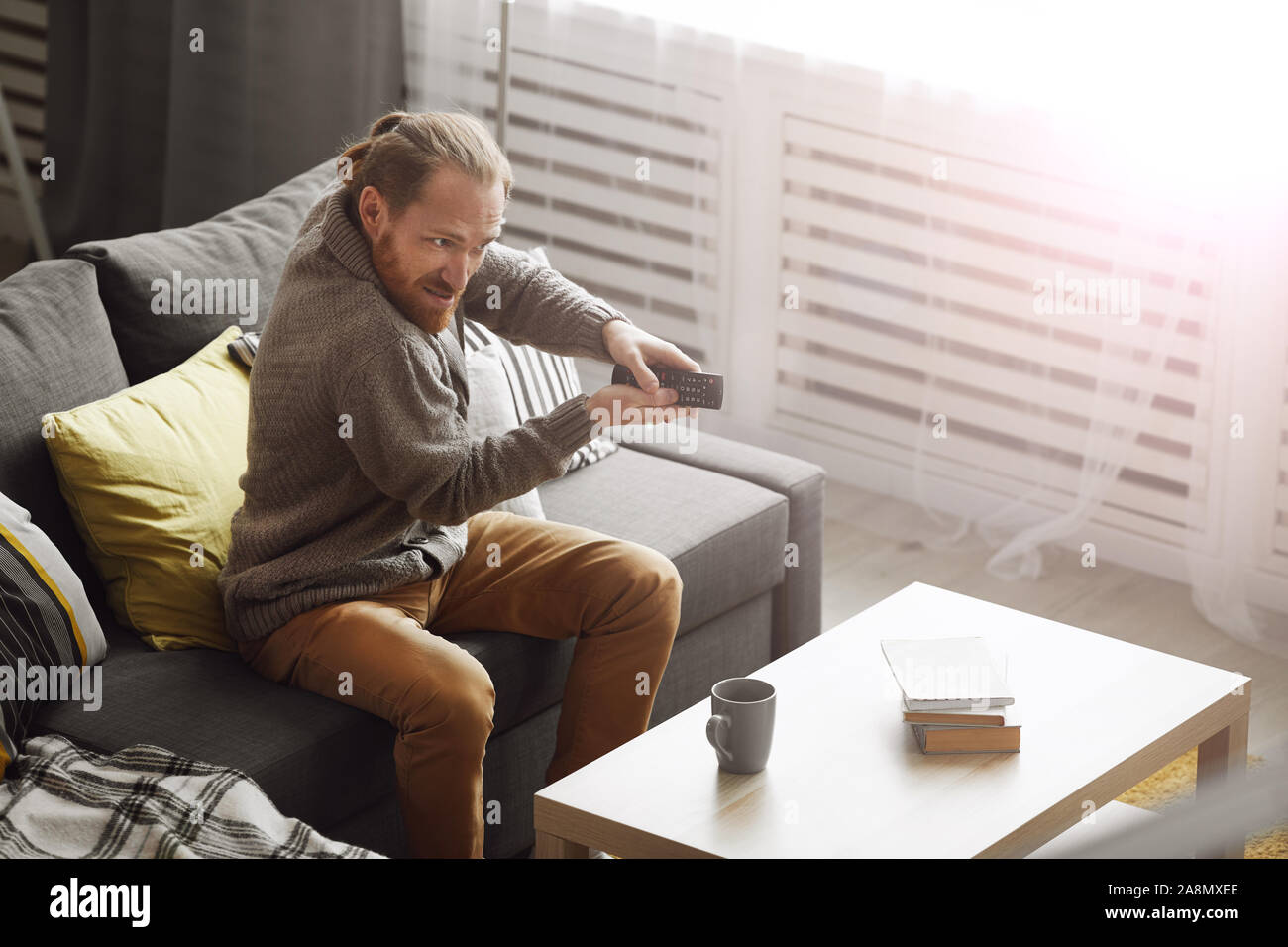 Remote control television frustrated hi-res stock photography and ...