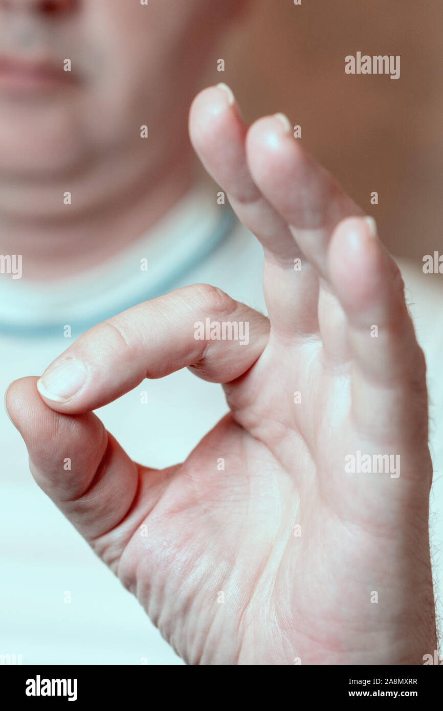 Man hand shows gesture OK. Close-up, soft focus Stock Photo - Alamy