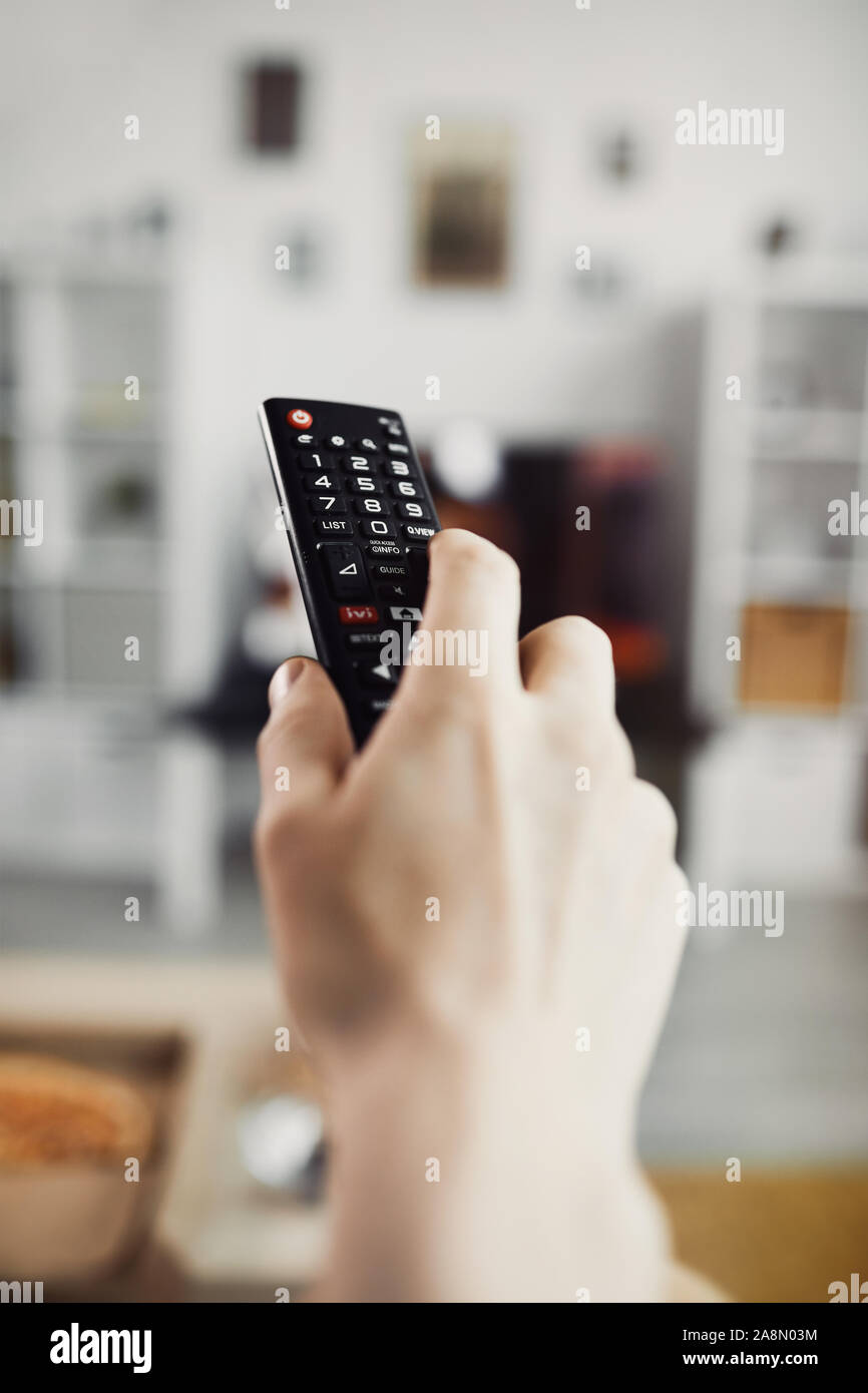 Hand holding tv remote hi-res stock photography and images - Alamy
