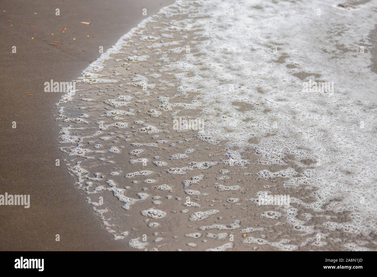 Wave on a beach with black sand, Tahiti, French Polynesia Stock Photo ...