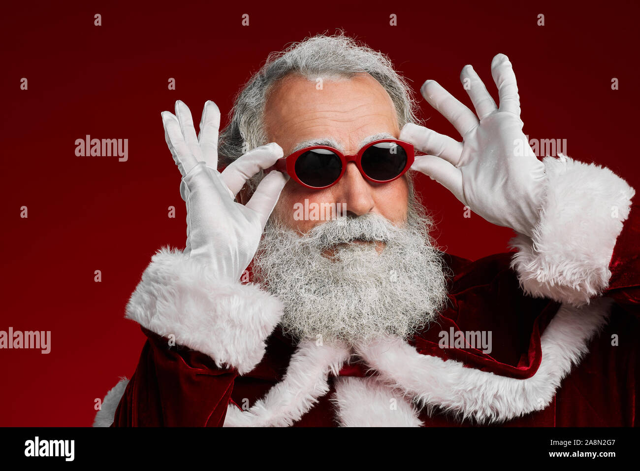 Head and shoulders portrait of funky Santa wearing sunglasses ready to ...