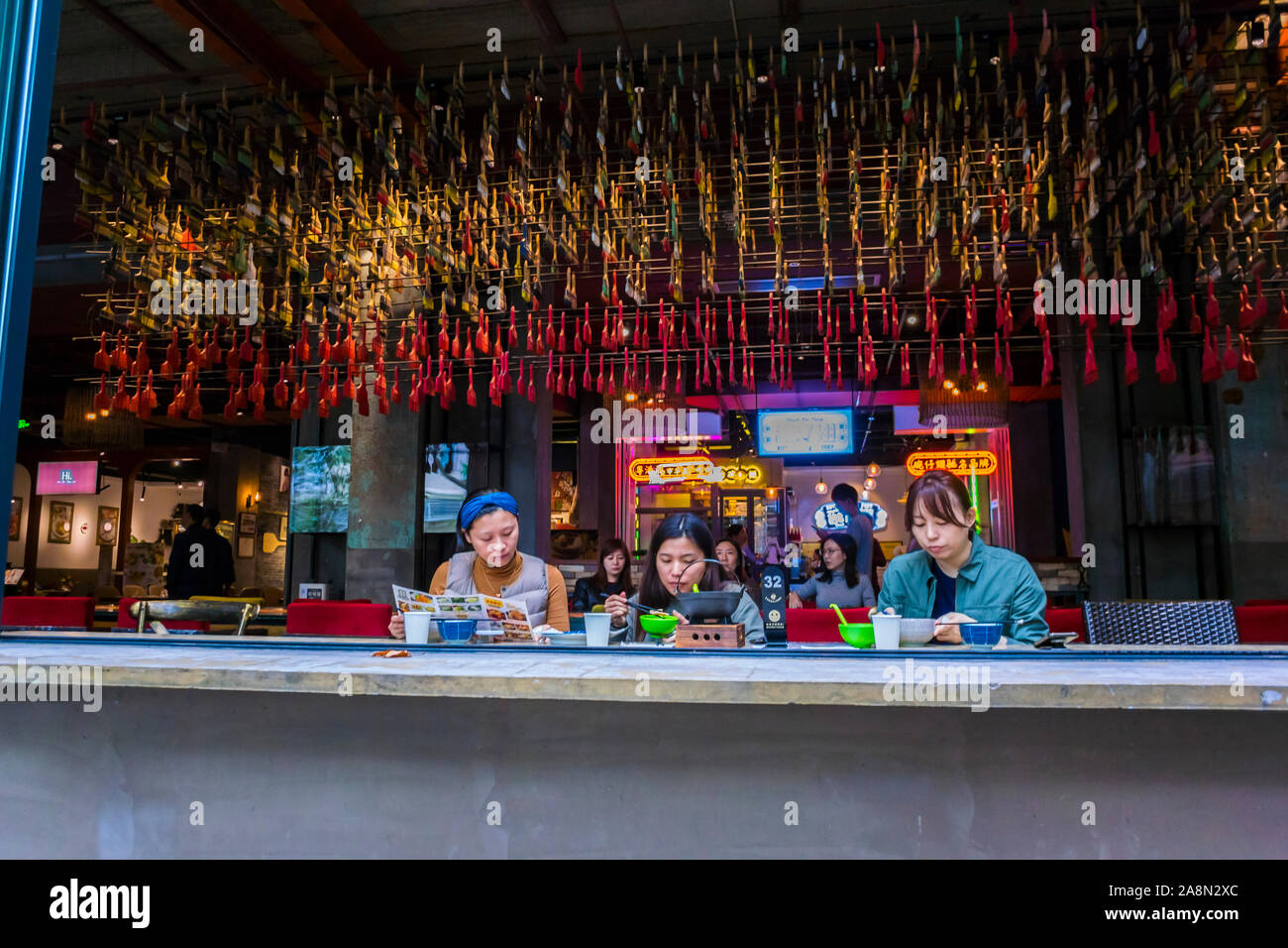 Shanghai, China, young Women inside Chinese Restaurant Window Enjoying ...