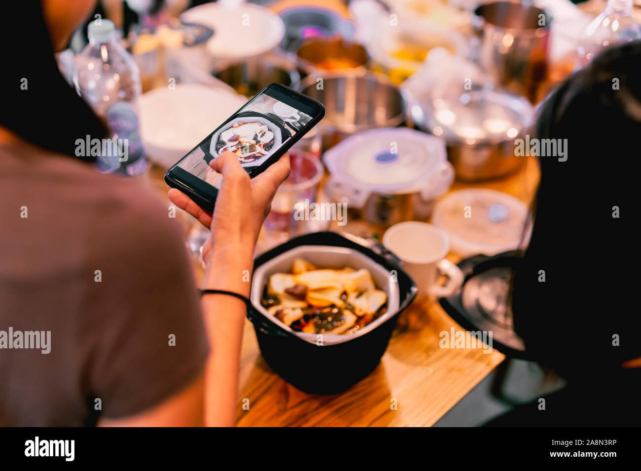 Female Friends having dinner party taking picture of food post on ...