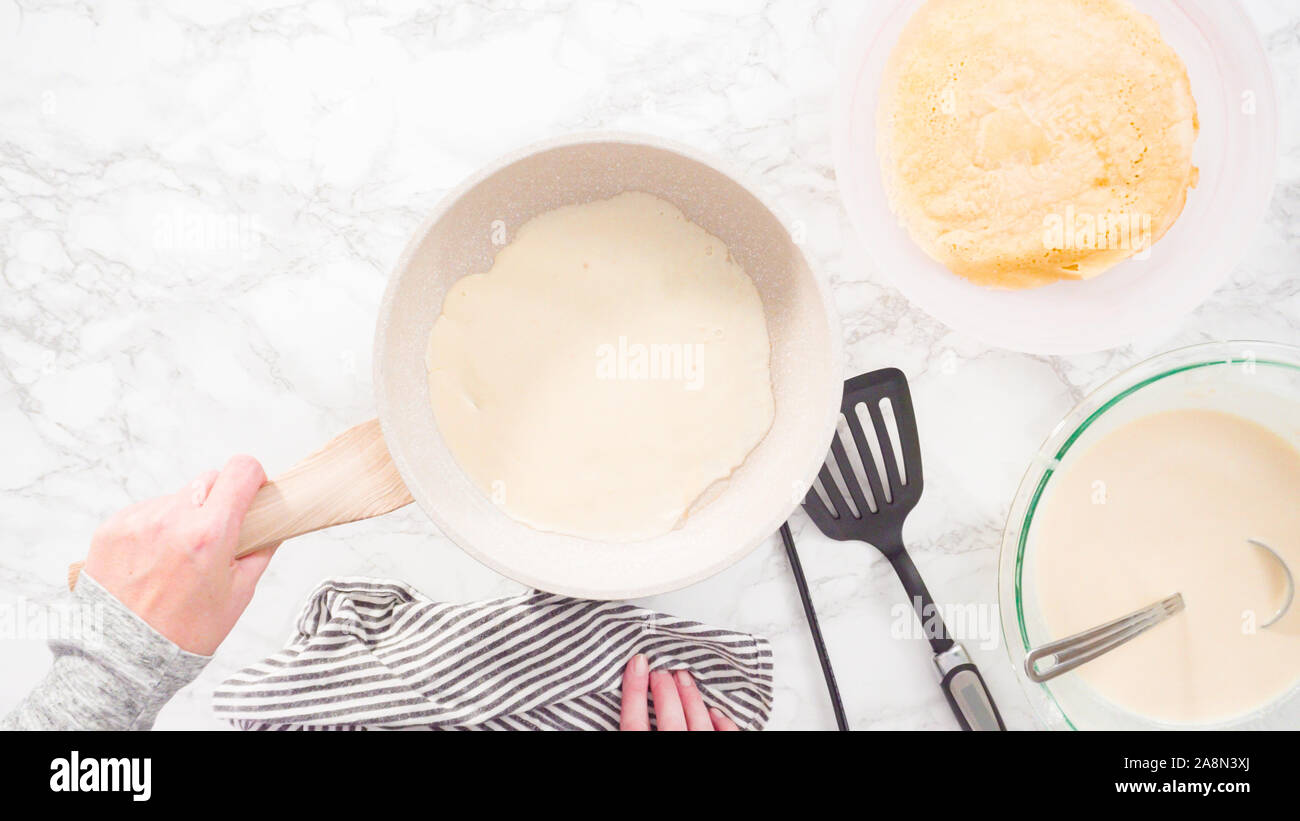 Flat lay. Making crepes in a small frying pan over medium heat Stock ...