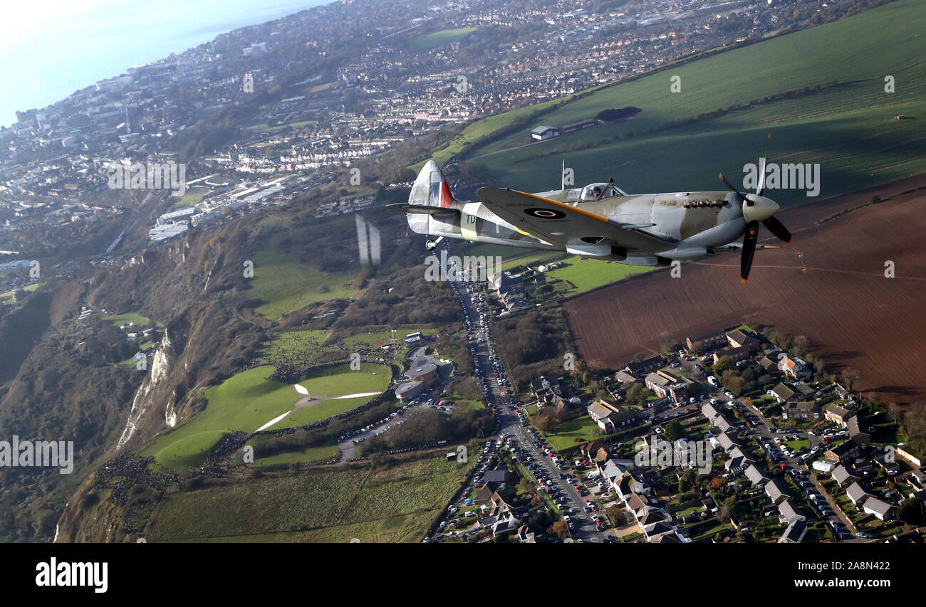 A World War II Spitfire, flies over the Battle of Britain Memorial in ...