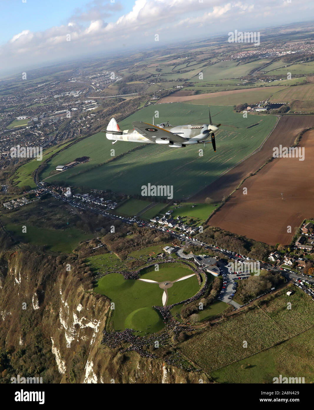 A World War II Spitfire, flies over the Battle of Britain Memorial in ...