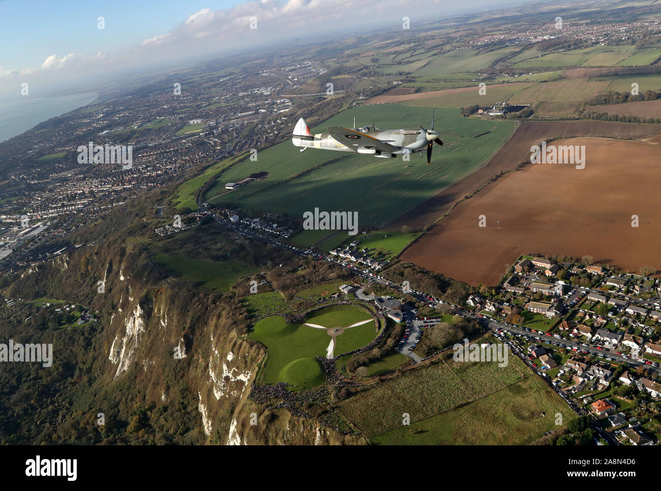 A World War II Spitfire, flies over the Battle of Britain Memorial in ...