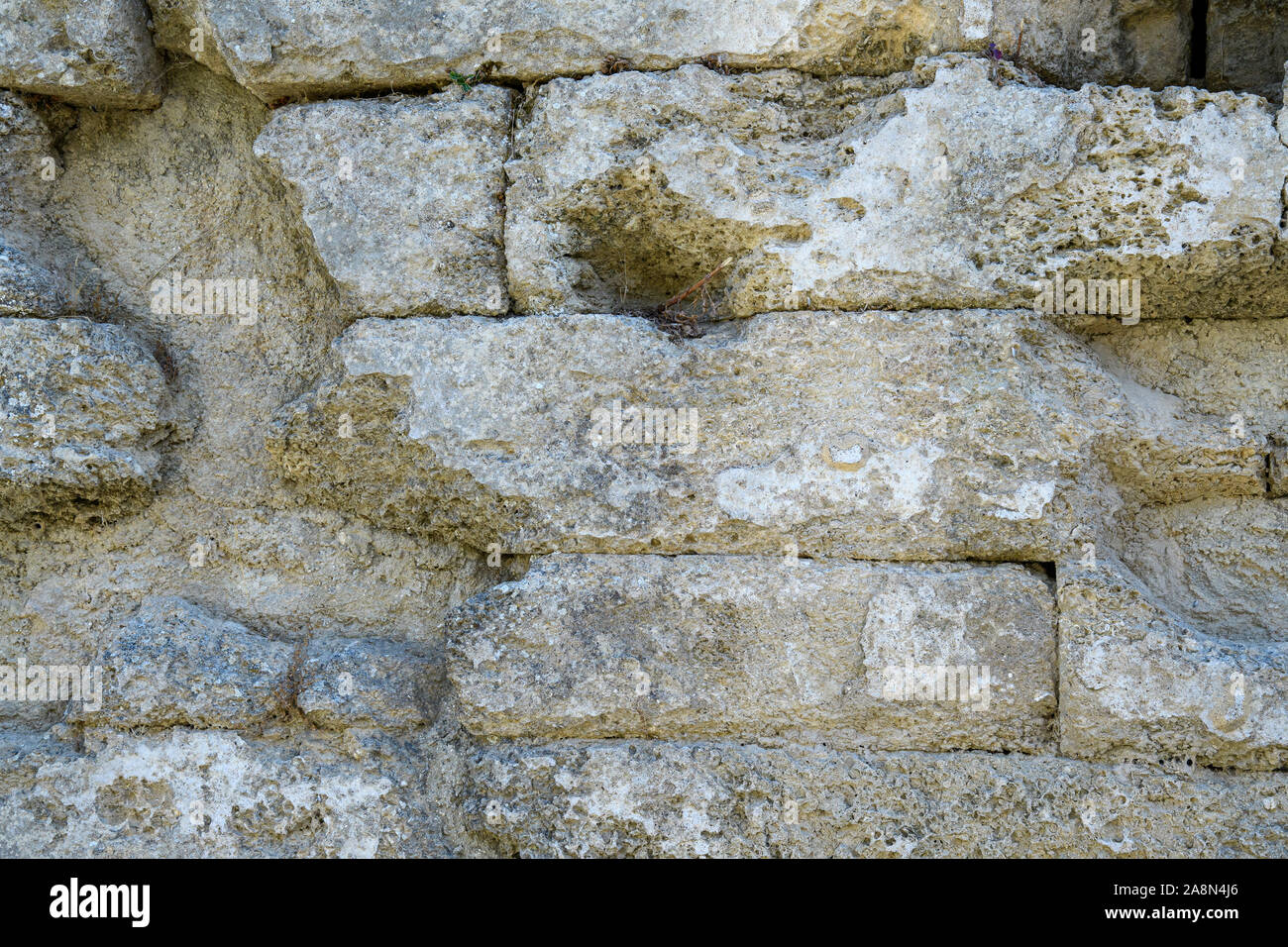 A fragment of the old stone wall of one of the temples of ancient Greek ...
