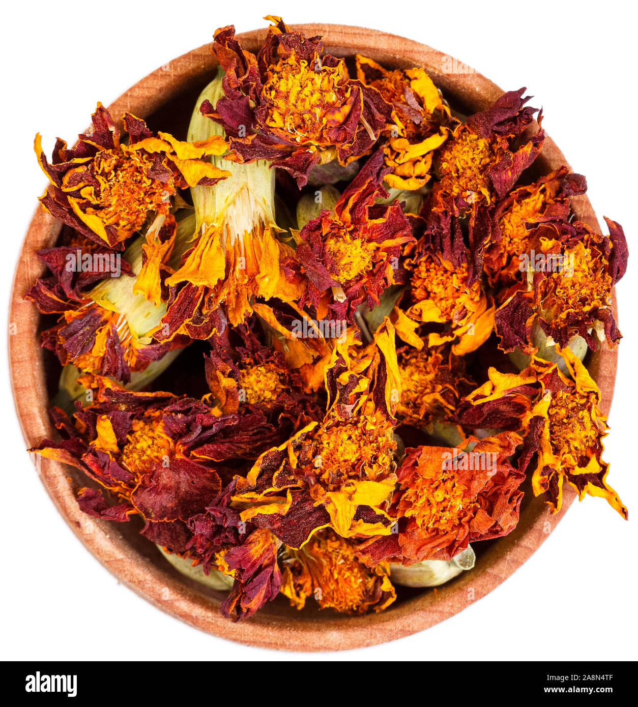 Dried Marigold flowers in a small wooden bow isolated on white, close ...