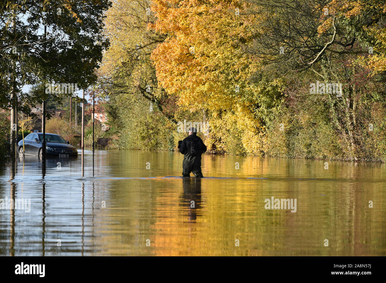 A man wades through floodwater in Fishlake, Doncaster as parts of ...