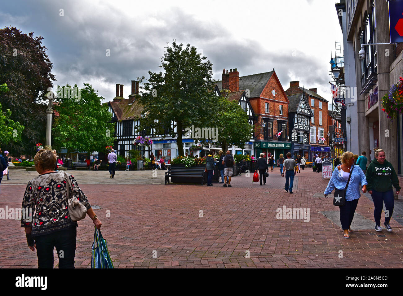 Shoppers stroll along the central square in the historic English town ...