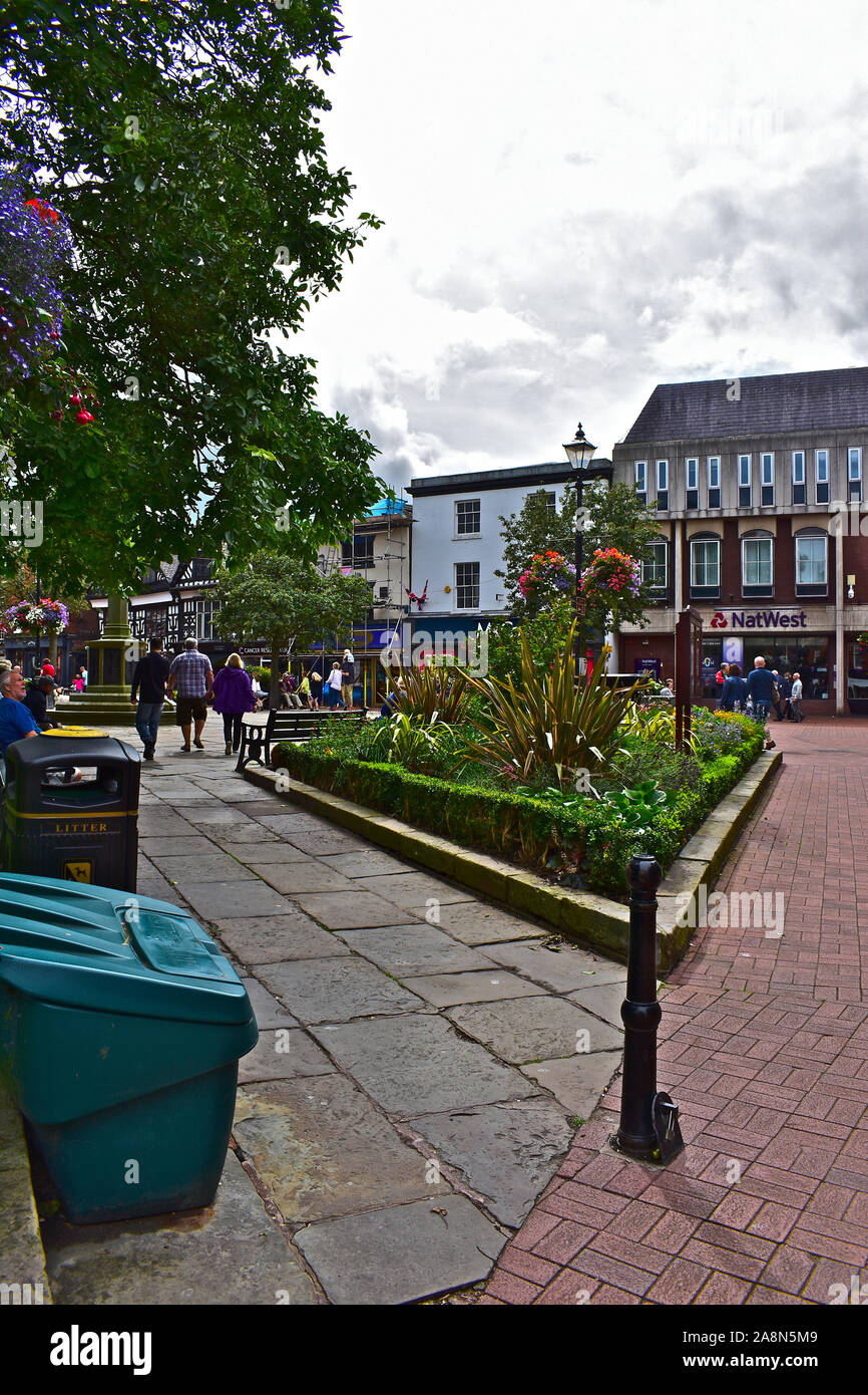 A street view of the central square in Nantwich with pretty flower beds ...