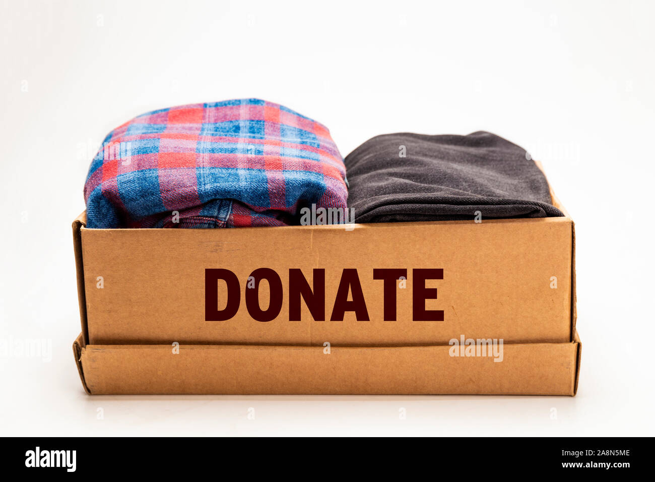 Donation concept. Donation box with donation clothes on a white ...