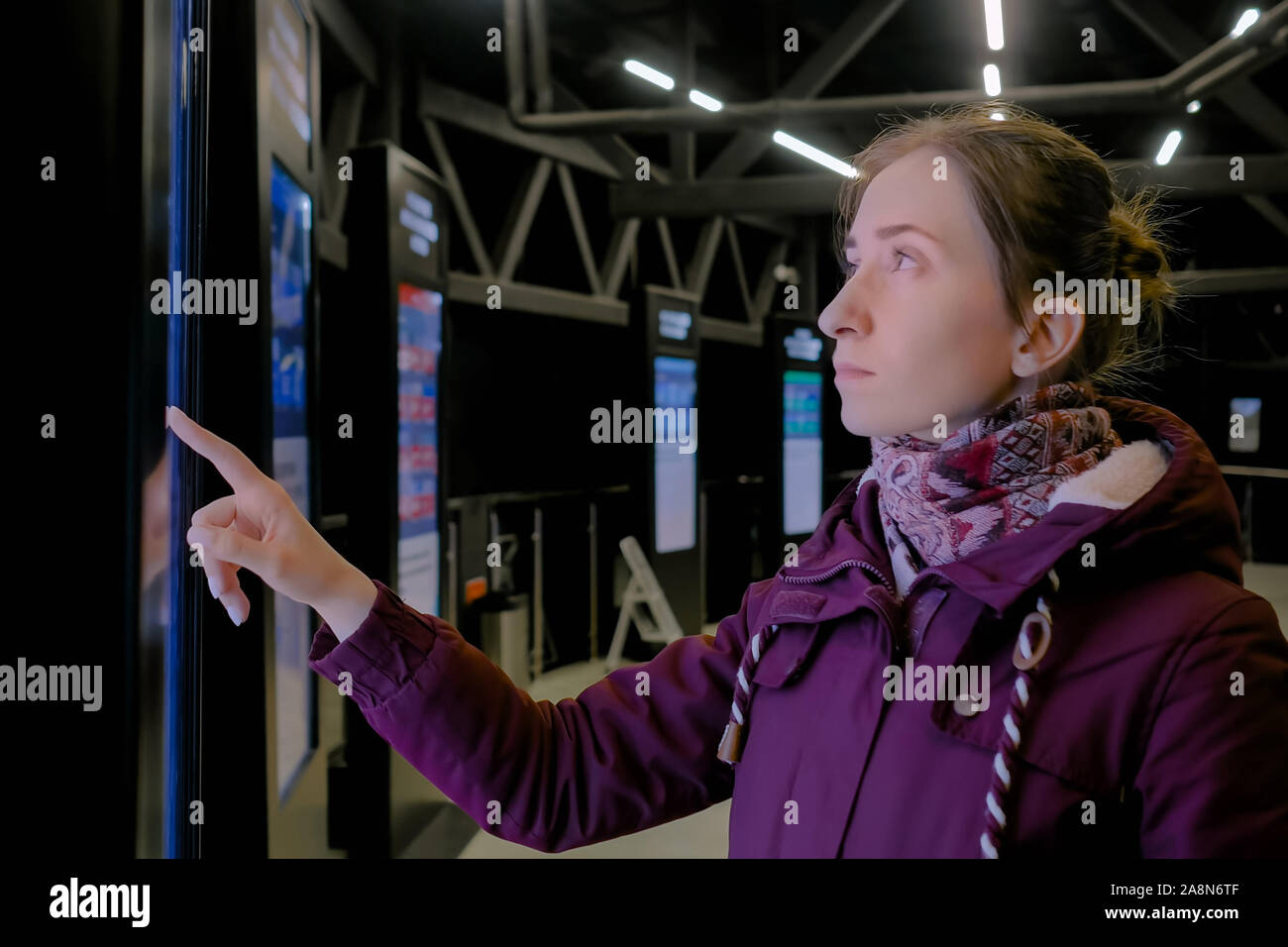 Woman using interactive touchscreen display of electronic multimedia ...