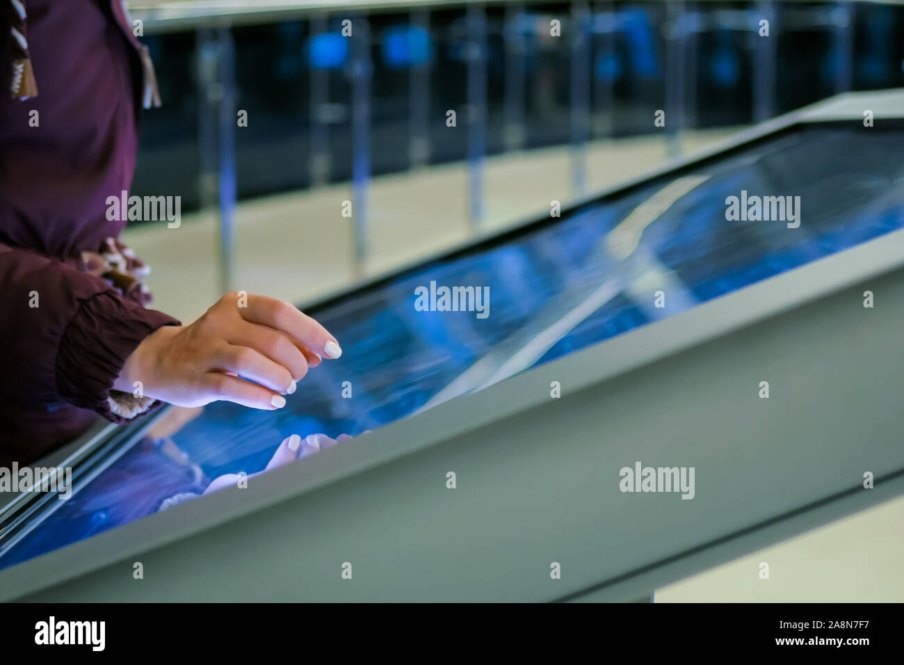 Woman using multimedia touchscreen display of interactive kiosk Stock ...