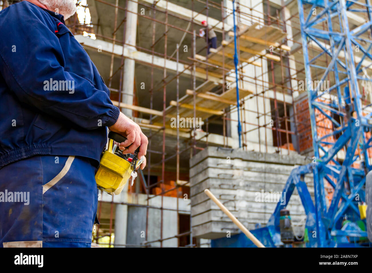 Operator, worker is holding industrial remote, wireless, console to ...