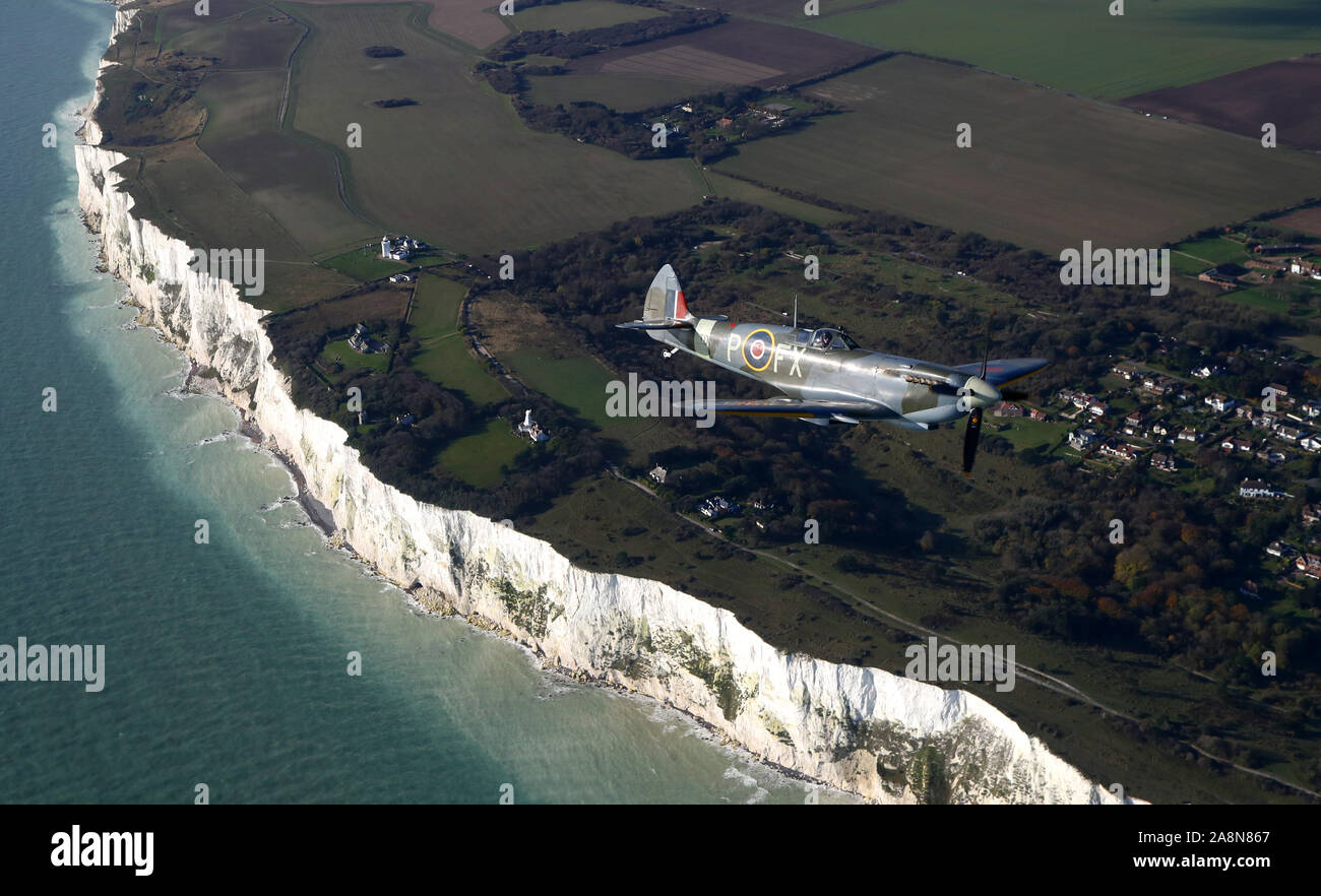 A World War II Spitfire, flies over the White Cliffs of Dover in Kent ...