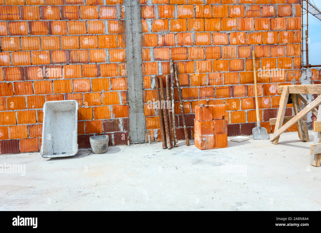 Set of different tools, equipment for brickwork with red blocks and ...