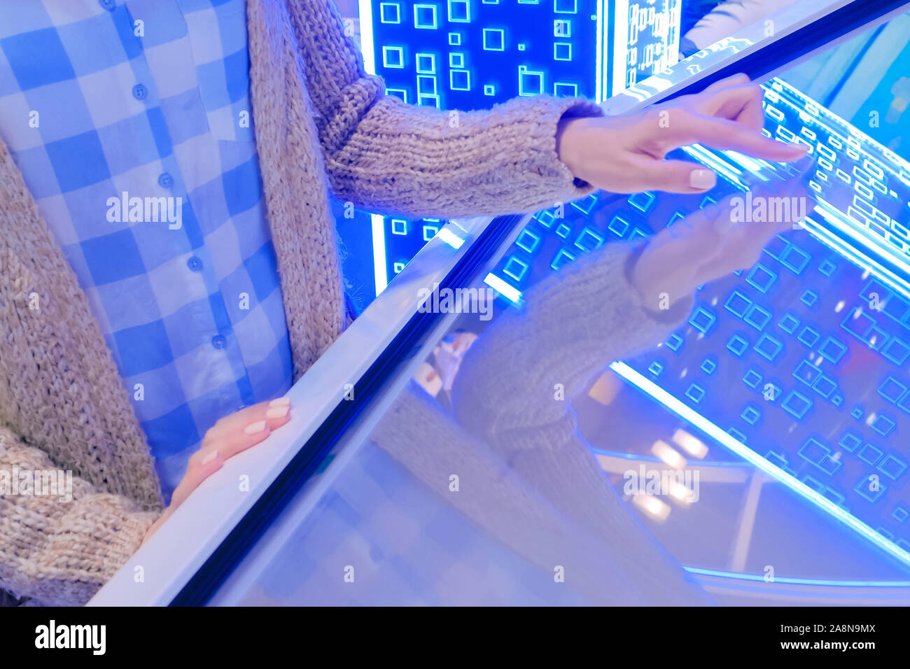 Woman using multimedia touchscreen display of interactive kiosk Stock ...