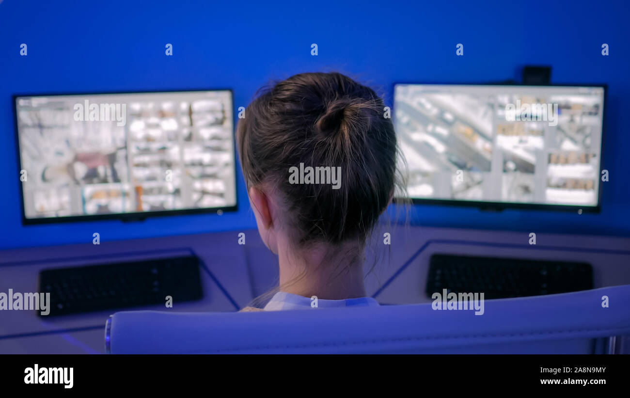 Woman security guard looking at modern cctv camera monitors Stock Photo ...