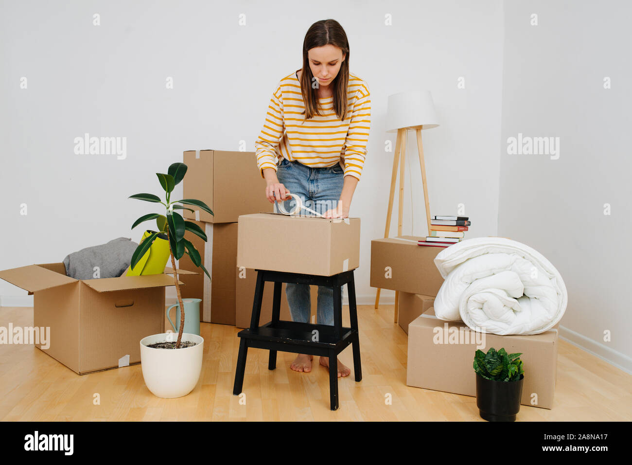 Woman packing moving box at home 30s adult hi-res stock photography and ...