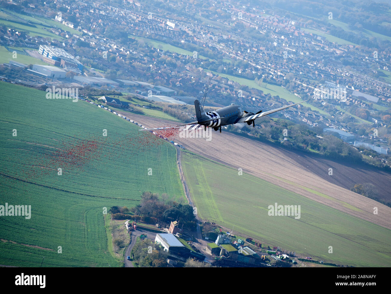 A World War II Dakota, with two Spitfires, drops three-quarters-of-a ...